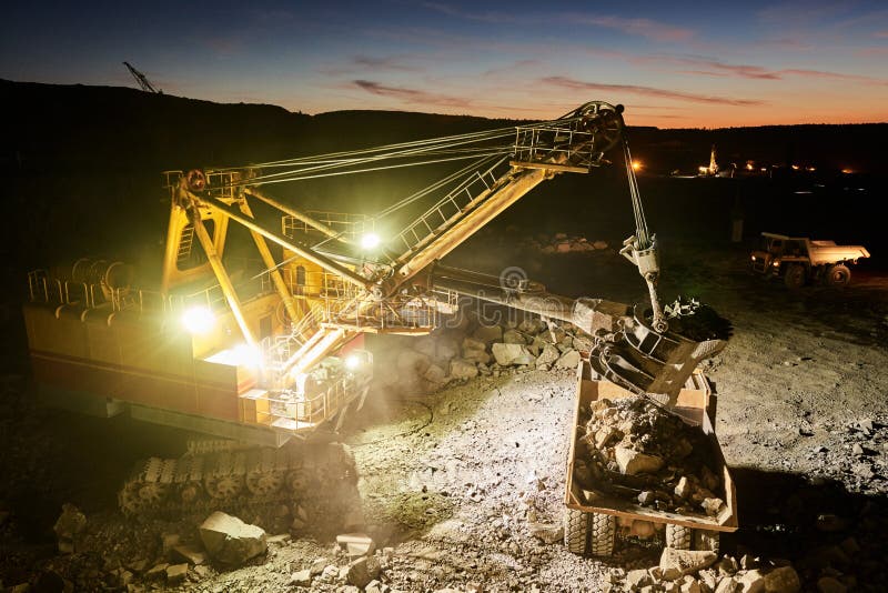 Mining. Excavator Loading Granite or Ore into Dump Truck Stock Photo ...