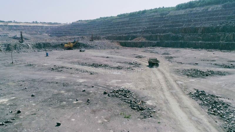 Mining Dump Trucks in Large Granite Open Pit Mine. Loaded Trucks Rides ...