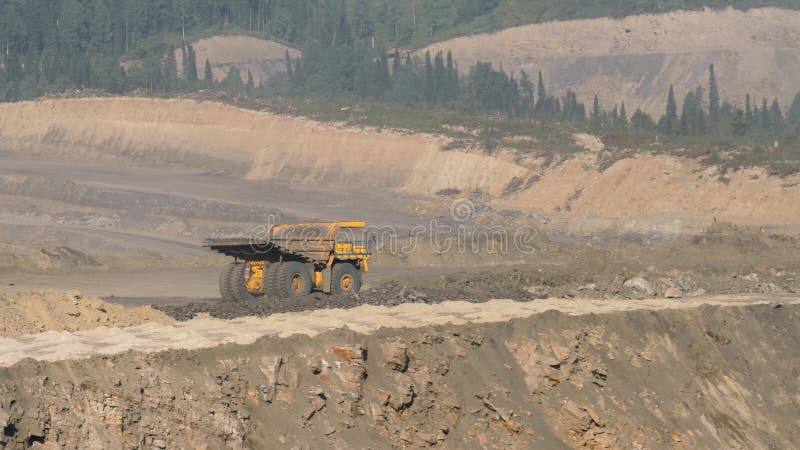 Mining Dump Trucks in the Open Pit Mine. the Dump Truck Goes on the ...