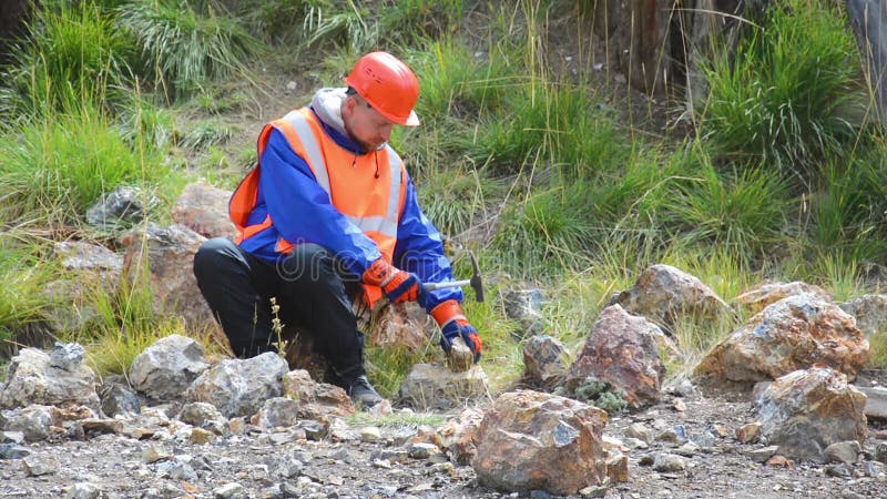 A Mining Engineer or Geologist Wearing Gloves, a Helmet, a Reflective ...