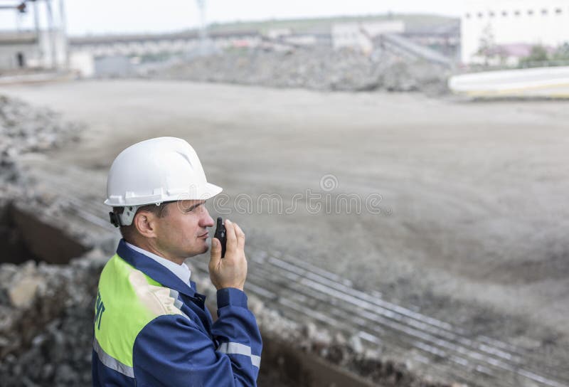 Mining Engineer in Yellow-blue Uniform White Helmet Supervises ...