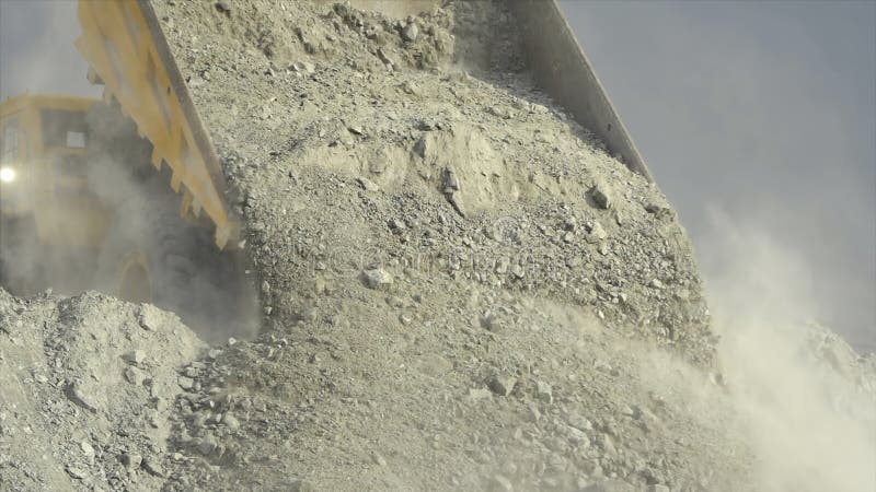 Mining Loader Unloads Limestone Ore or Rock. View from the Back. Stock ...