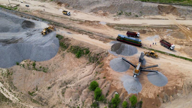Front End Loader Loading Sand into Dump Truck in Open Pit Mine. Wheel ...