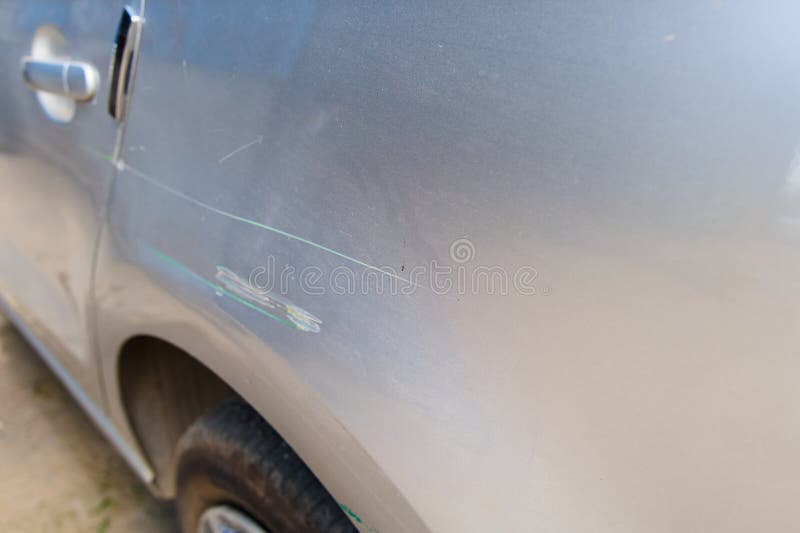 Minor Scratch on the Side of a Silver Vehicle Parked in a Rustic ...