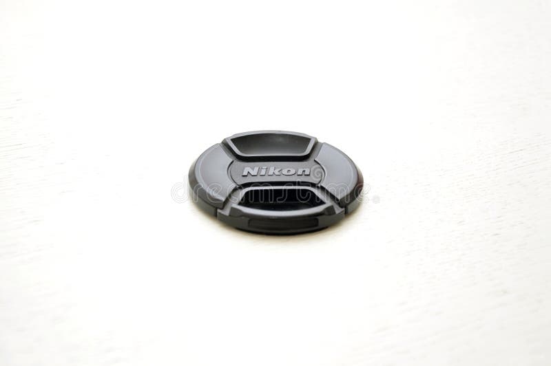 Old Lens Cap for a Nikon Camera on a White Table Surface. Editorial ...