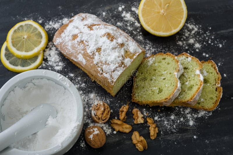 Mint Cake on Black Surface with Lemon, Nuts, Powdered Sugar Stock Image ...