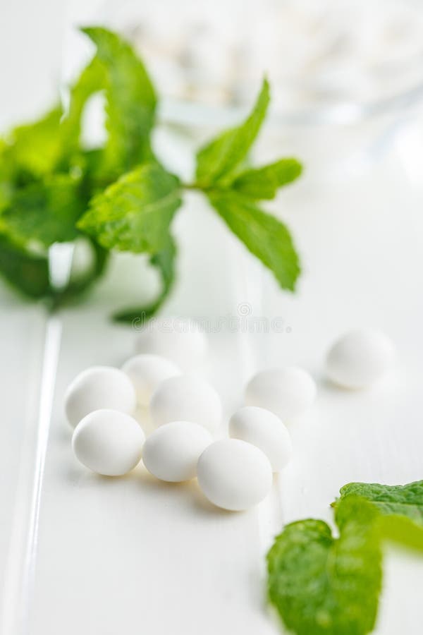 Mint Candies. Menthol Bonbons and Mint Leaves on White Table Stock ...