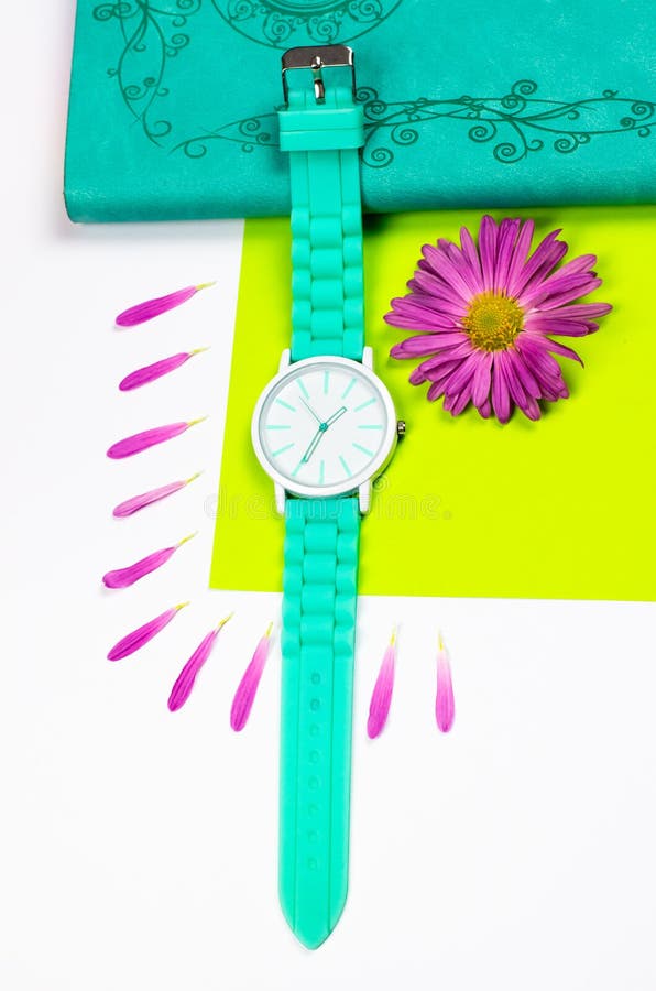 A Mint-colored Watch is on a Notebook. Notepad and Clock with Flower ...