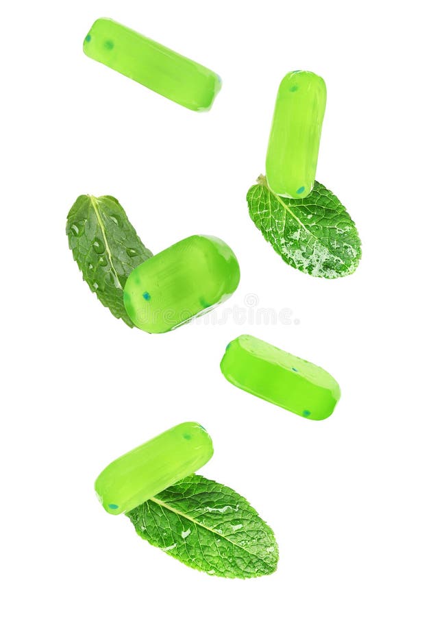 Mint Hard Candies and Green Leaves Falling on White Background Stock ...