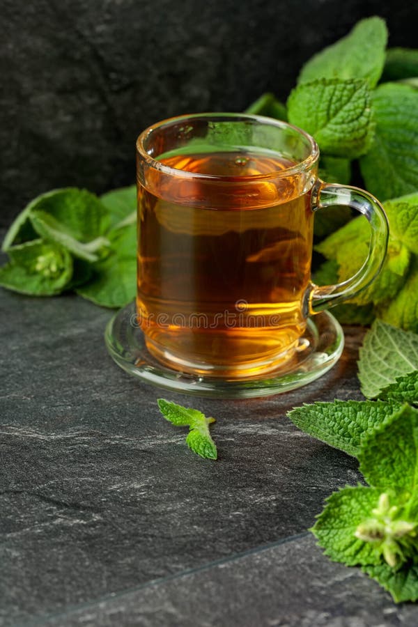 Mint tea on a black table stock photo. Image of glass - 260024744