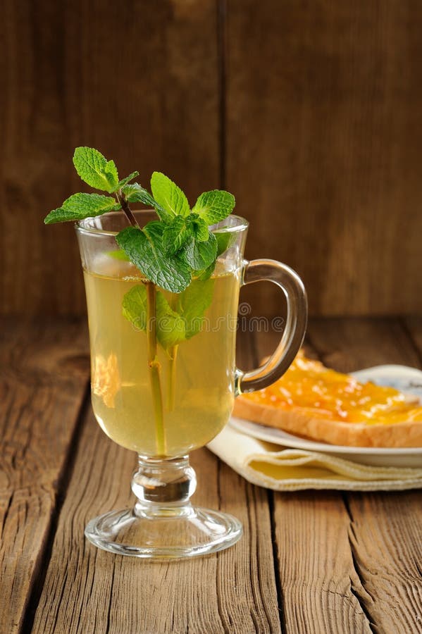 Mint Tea and Toasts with Orange Marmalade on Wooden Background Stock ...
