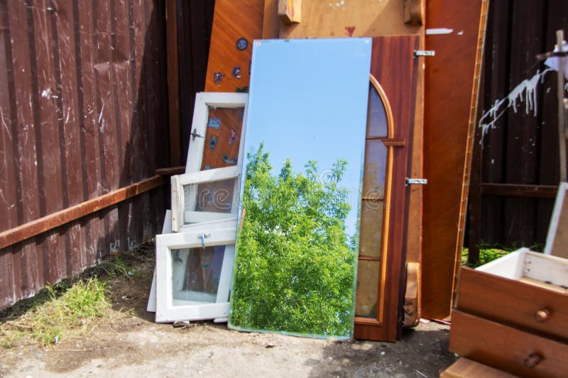 A Mirror is Currently Placed Atop a Large, Messy Pile of Junk Stock ...