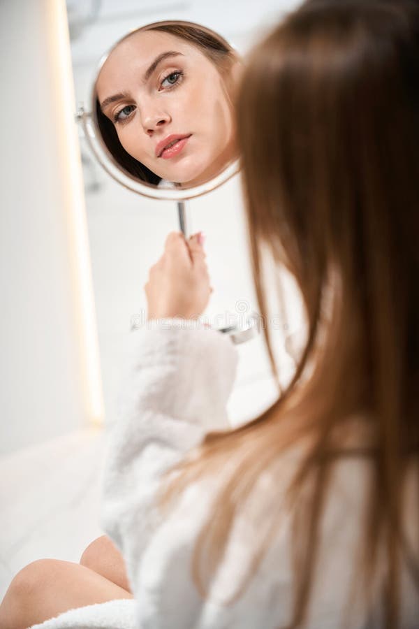Mirror Reflection of Young Beautiful Focused Caucasian Woman Looking at ...