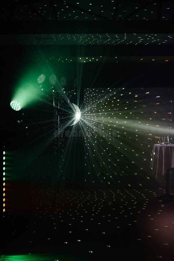 A Mirrored Disco Ball Reflects Light Rays Throughout the Room. Smoke ...