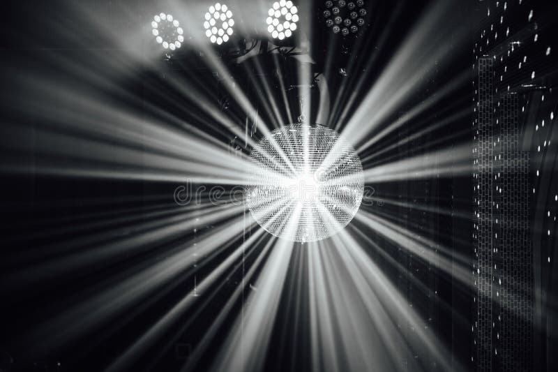 A Mirrored Disco Ball Reflects Light Rays Throughout the Room. Smoke ...