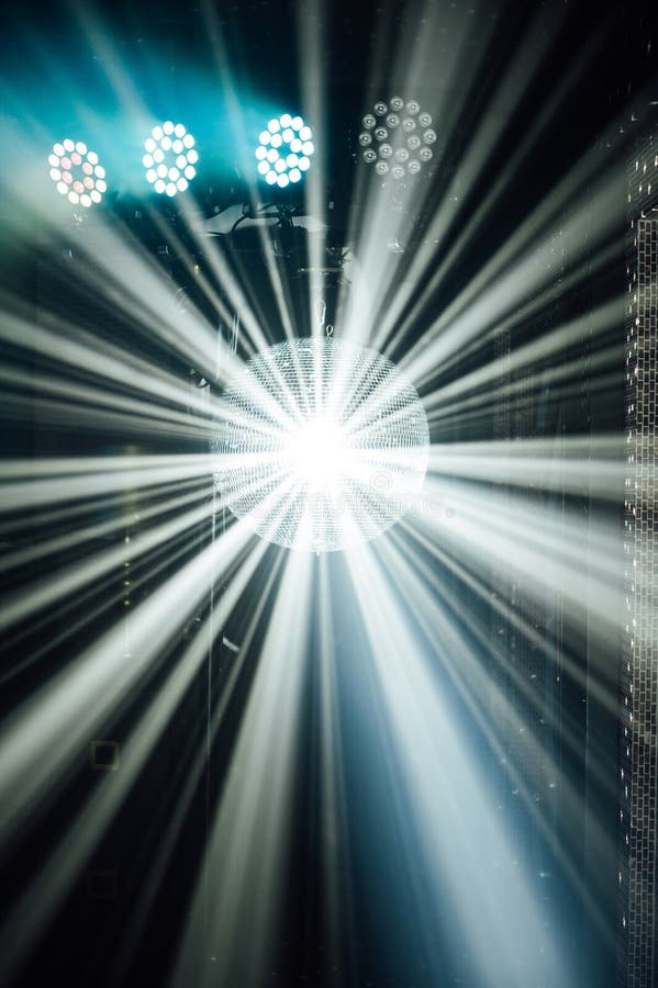 A Mirrored Disco Ball Reflects Light Rays Throughout the Room. Smoke ...