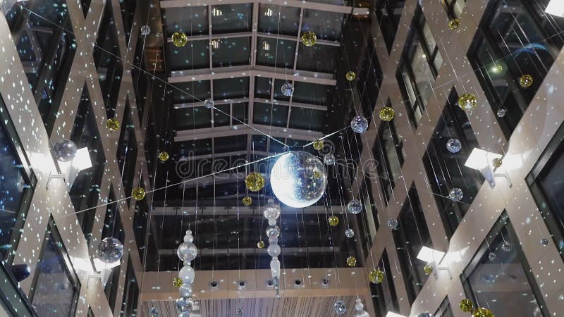 A Mirrored Disco Ball Suspended from the Ceiling Inside a High-rise ...