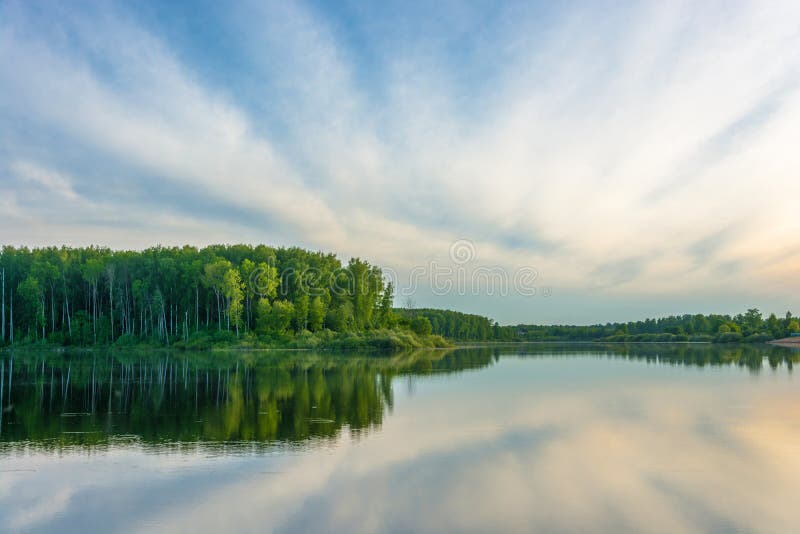 Reflection of the Sky with Clouds and the Sun in the Blue Water of a ...