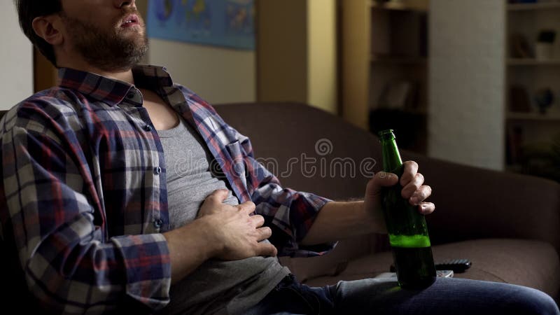 Miserable Alcoholic Scratching Belly with Bottle of Beer in Hand ...