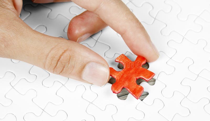 Hand Inserting Missing Piece of Jigsaw Puzzle Stock Photo - Image of ...