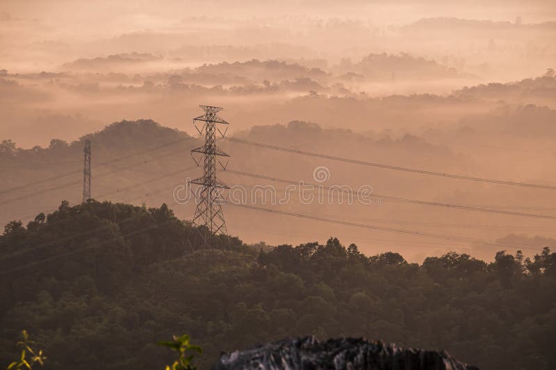 Mist Flows through a Valley and There are Lines of Electrical ...