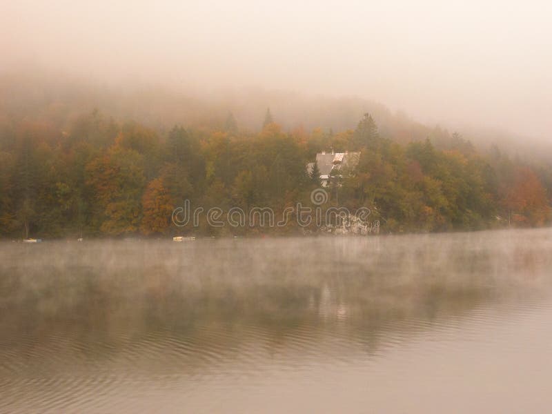 Mist Over the Lake with Colorful Trees and House. Stock Image - Image ...