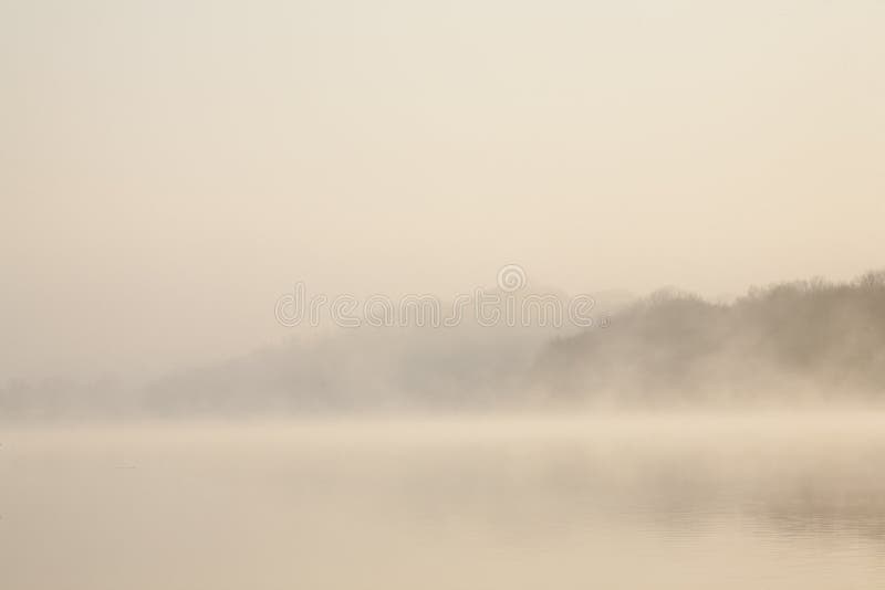 Mist Over a Lake with Trees in the Background Stock Image - Image of ...