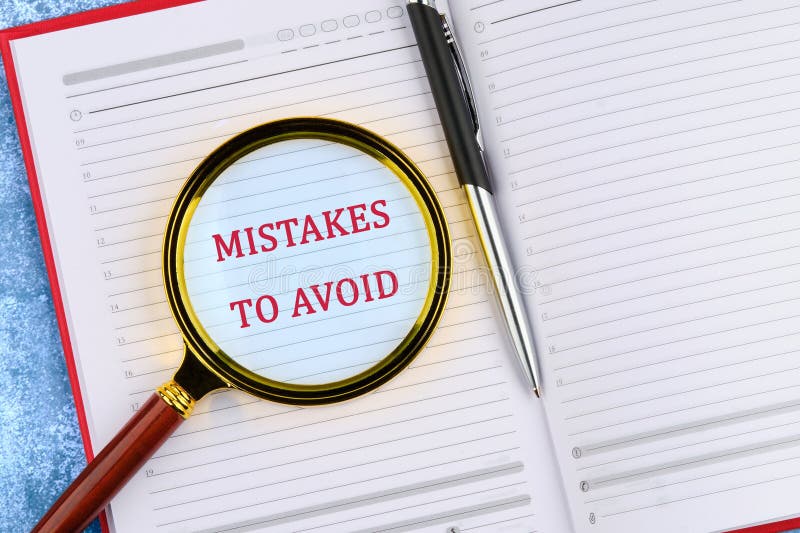MISTAKES TO AVOID, Text through a Magnifying Glass in an Open Business ...