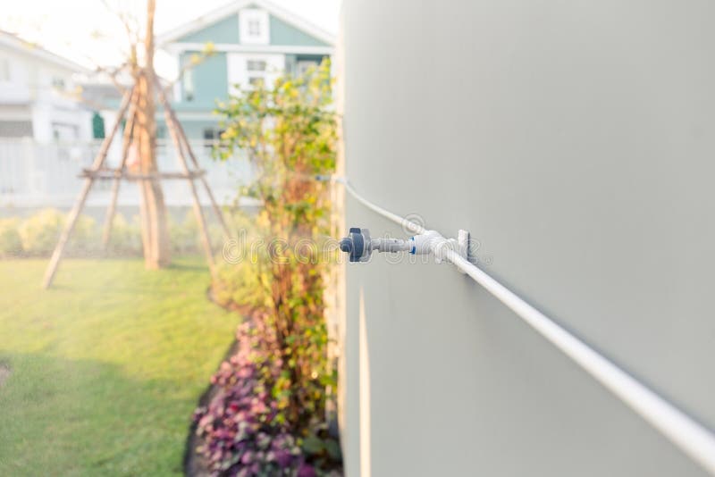 Misting sprinkler garden stock photo. Image of cooling - 143965740