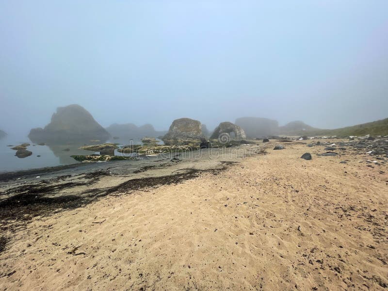 Misty Beach at Ballintoy with Rock Formations Stock Photo - Image of ...