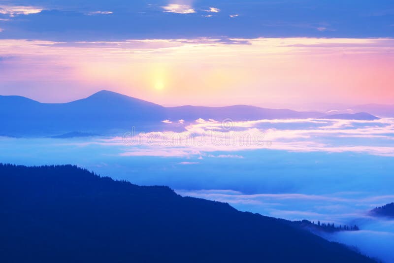 Misty Clouds in the Mountains at Sunrise Stock Photo - Image of ...
