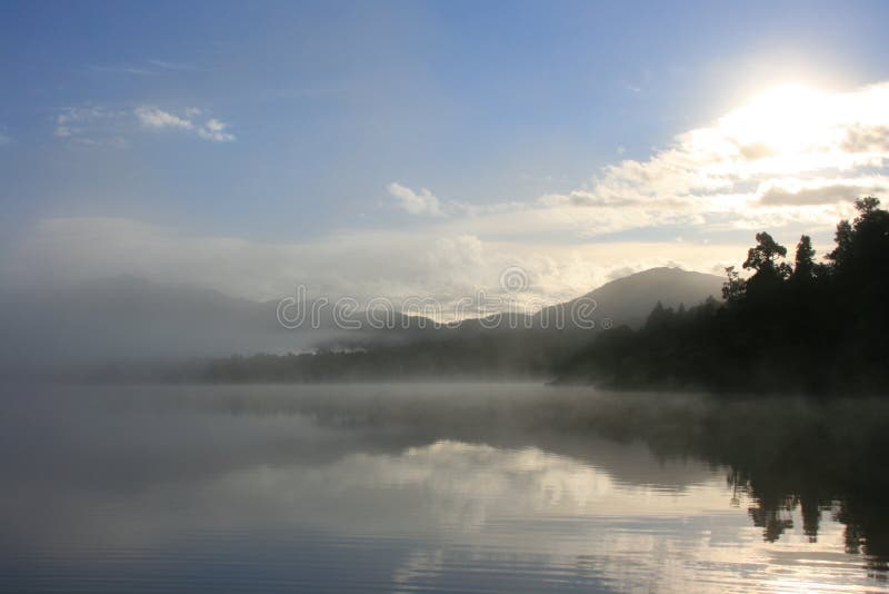 Misty Lake stock photo. Image of canoe, bird, mountain - 14873930