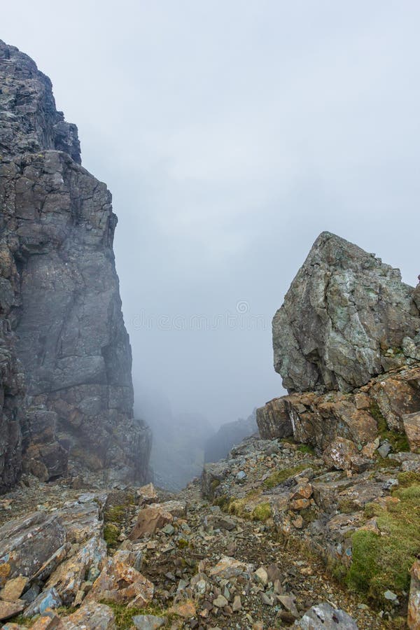 A Misty Mountain Gully View with Fog and White Altitude Clouds Stock ...