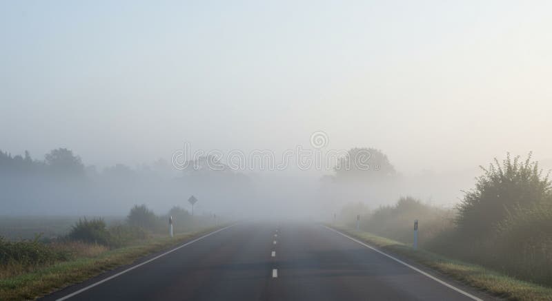 Misty Road through a Rural Landscape at Sunrise Stock Illustration ...