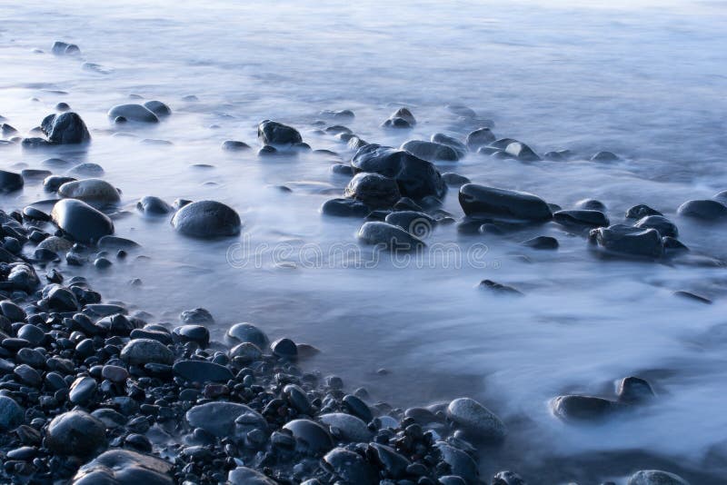 Misty Waves on Rock Beach stock image. Image of rocks - 66528461
