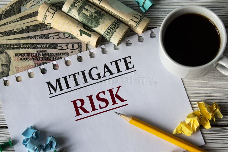 MITIGATE RISK - Words on a White Sheet Against a Background of ...