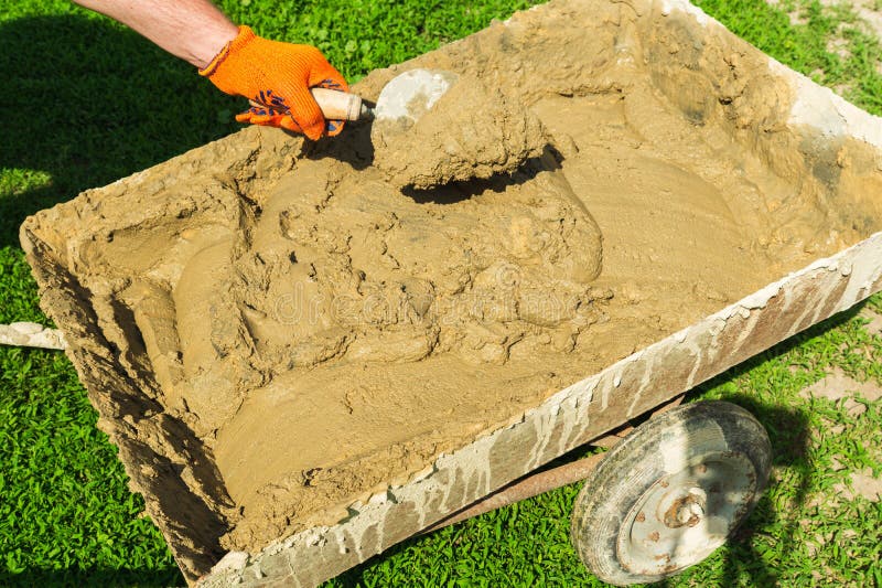 Mix the Cement with Sand and Water with a Trowel. Builder is Hand in a ...