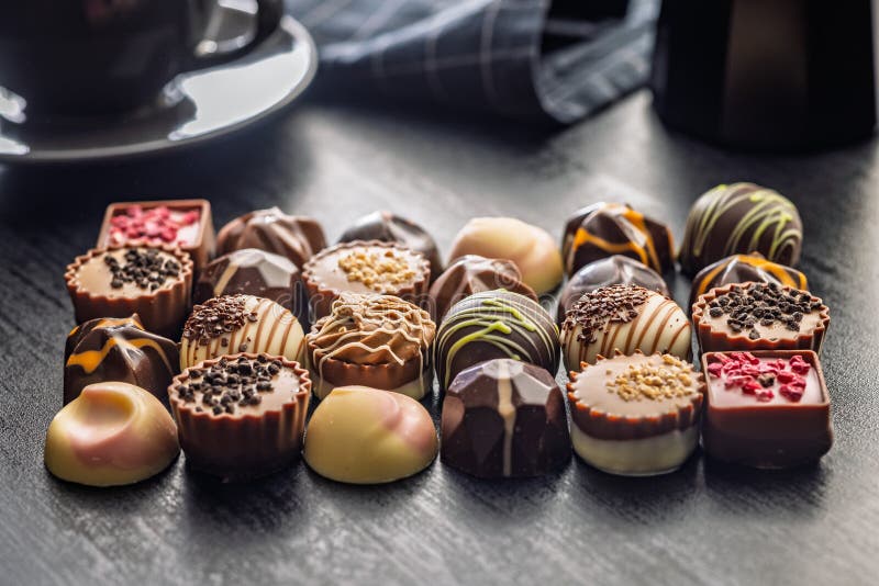 Mix of Chocolate Pralines on Black Table Stock Photo - Image of variety ...