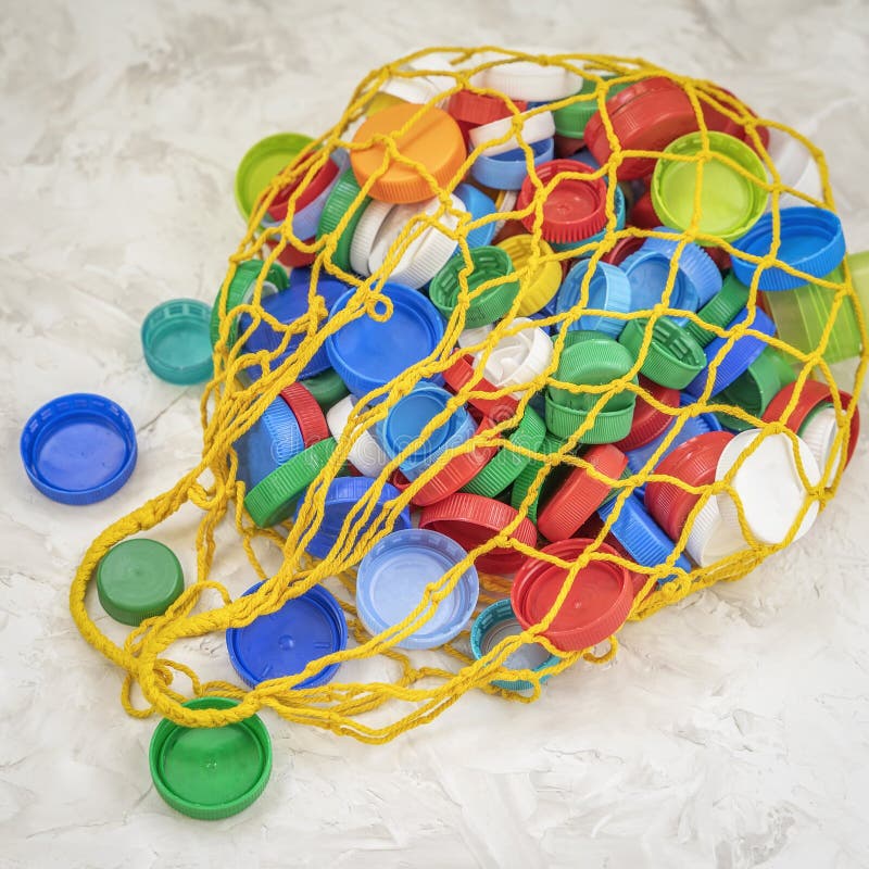 Colored Plastic Caps Ready To Be Recycled on Polyethylene. Concept of ...
