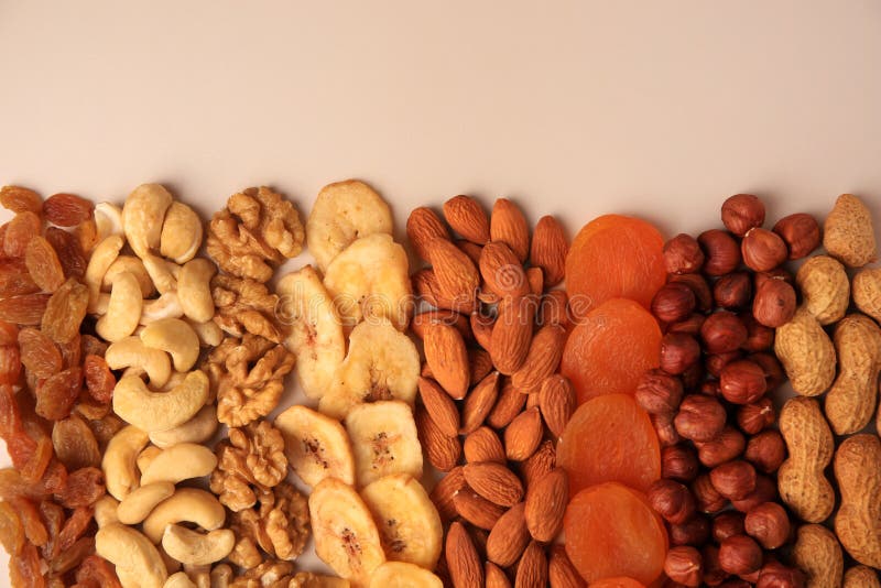 Mix of Delicious Dried Nuts and Fruits on Beige Background, Flat Lay ...