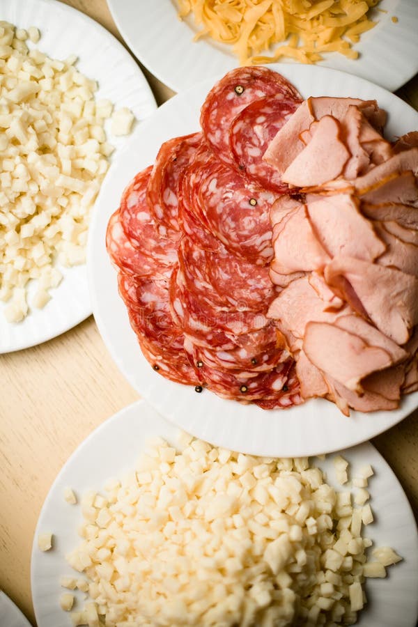 Mix of Different Snacks and Appetizers on White Plates. Sausage, Cheese ...