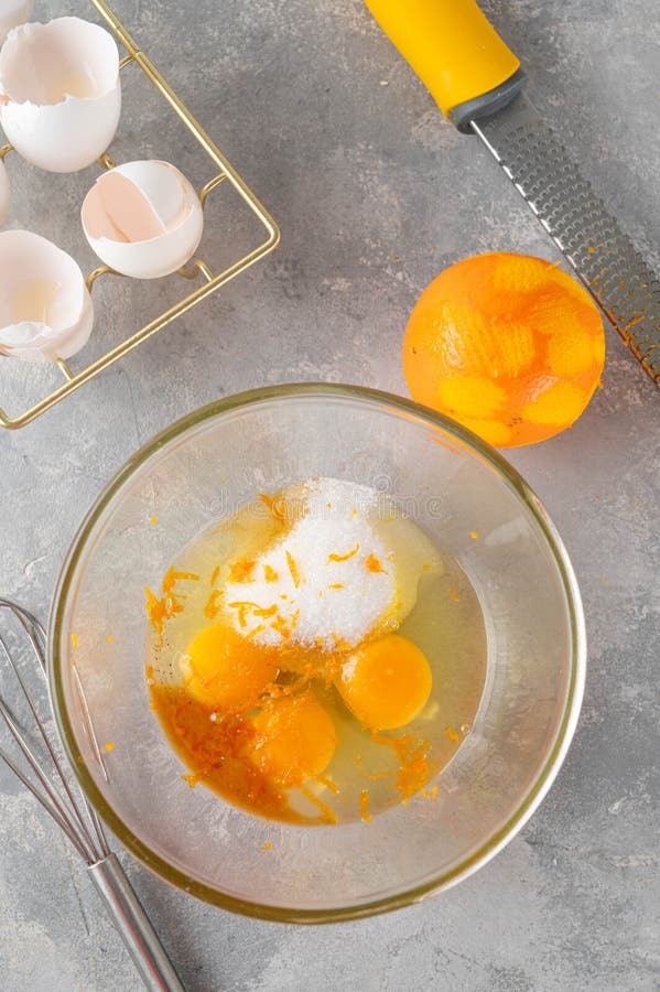 Mix of Eggs, Vanilla, Sugar and Orange Peel in a Bowl on a Gray ...