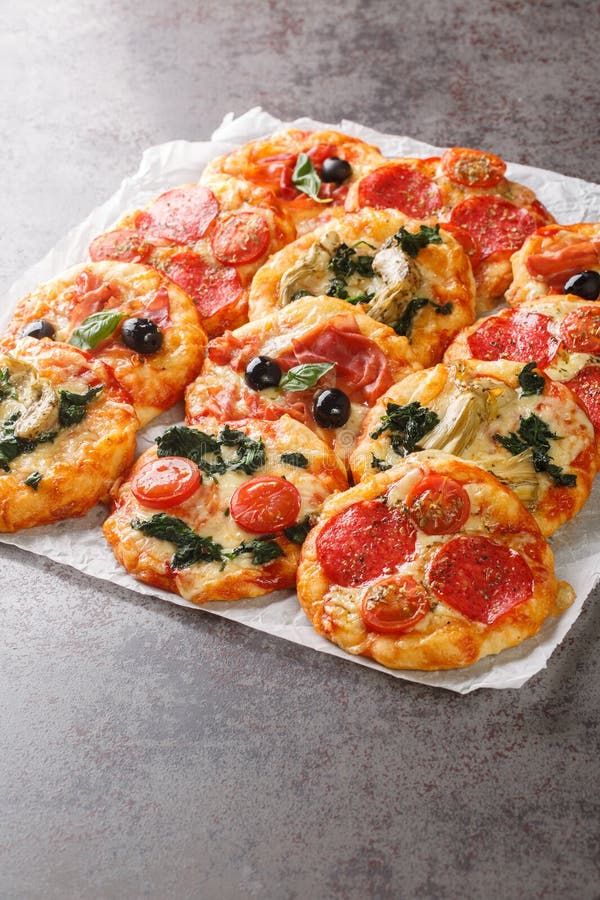 Mix Mini Pizza or Pizzette with Various Toppings Close-up on Parchment ...