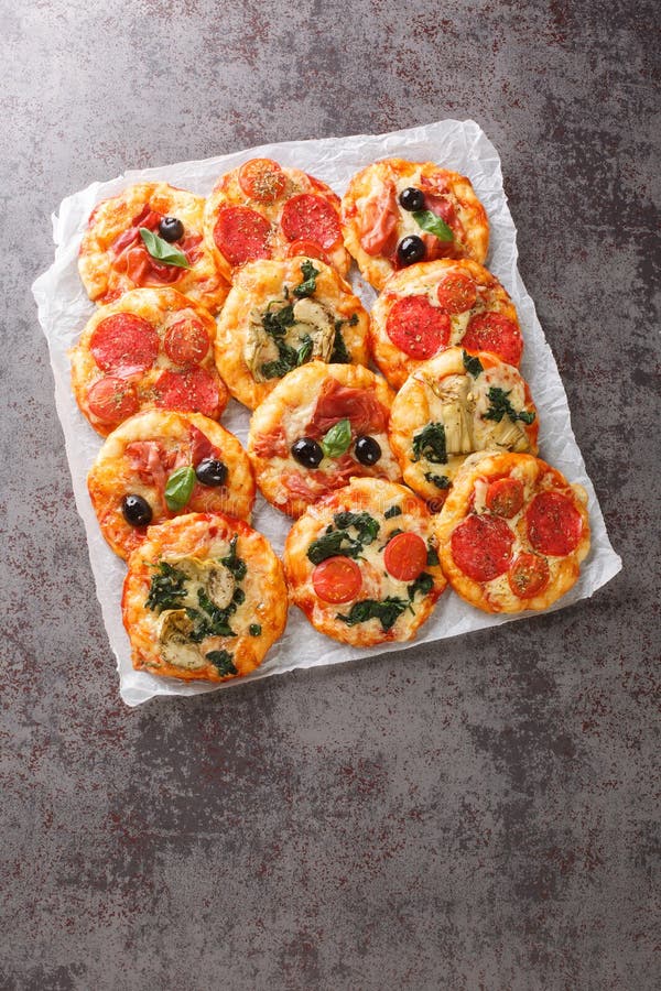 Mix Mini Pizza or Pizzette with Various Toppings Close-up on Parchment ...