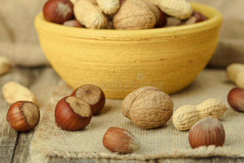 A Mix of Nuts in a Shell, in a Clay Plate Stock Image - Image of ...