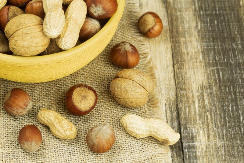A Mix of Nuts in a Shell, in a Clay Plate Stock Photo - Image of walnut ...