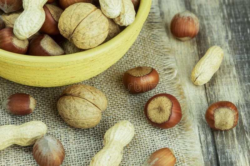 A Mix of Nuts in a Shell, in a Clay Plate Stock Photo - Image of nuts ...