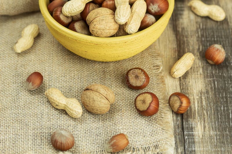 A Mix of Nuts in a Shell, in a Clay Plate Stock Photo - Image of ...