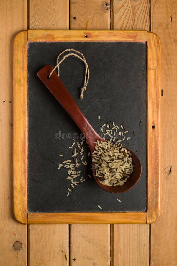 Mix of Rice in a Wooden Spoon on a Chalkboard Stock Photo - Image of ...