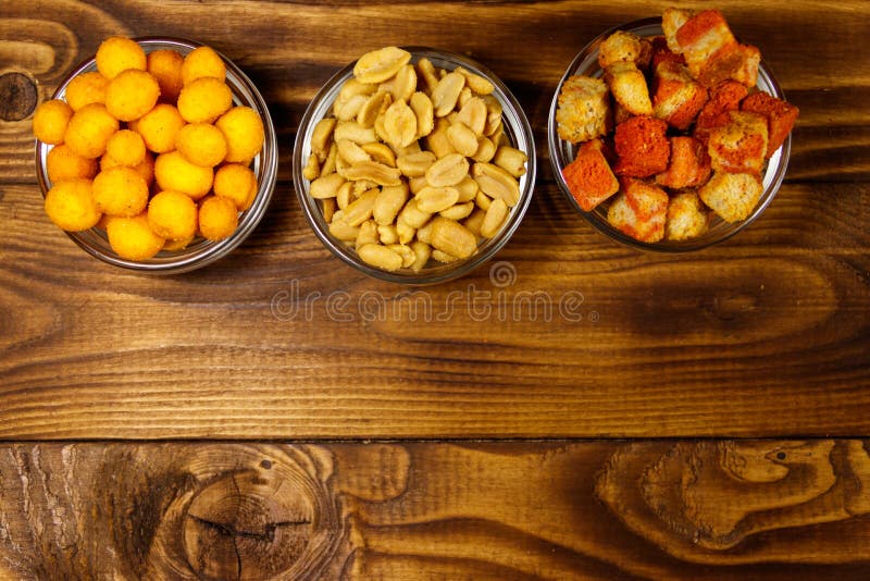 Mix of Snacks for Beer on Wooden Table Stock Photo - Image of bowl ...